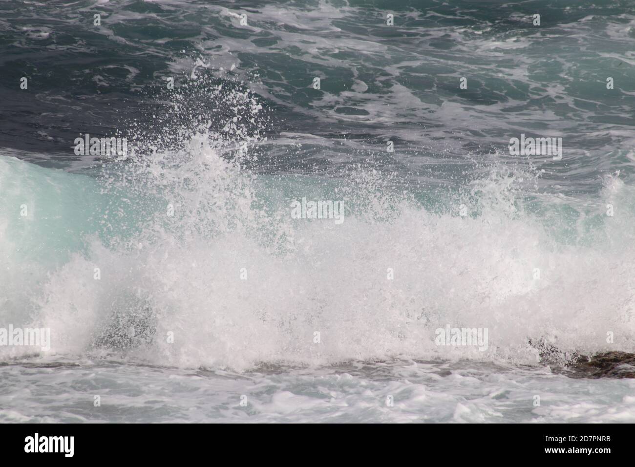 Waves breaking on rocks Stock Photo - Alamy
