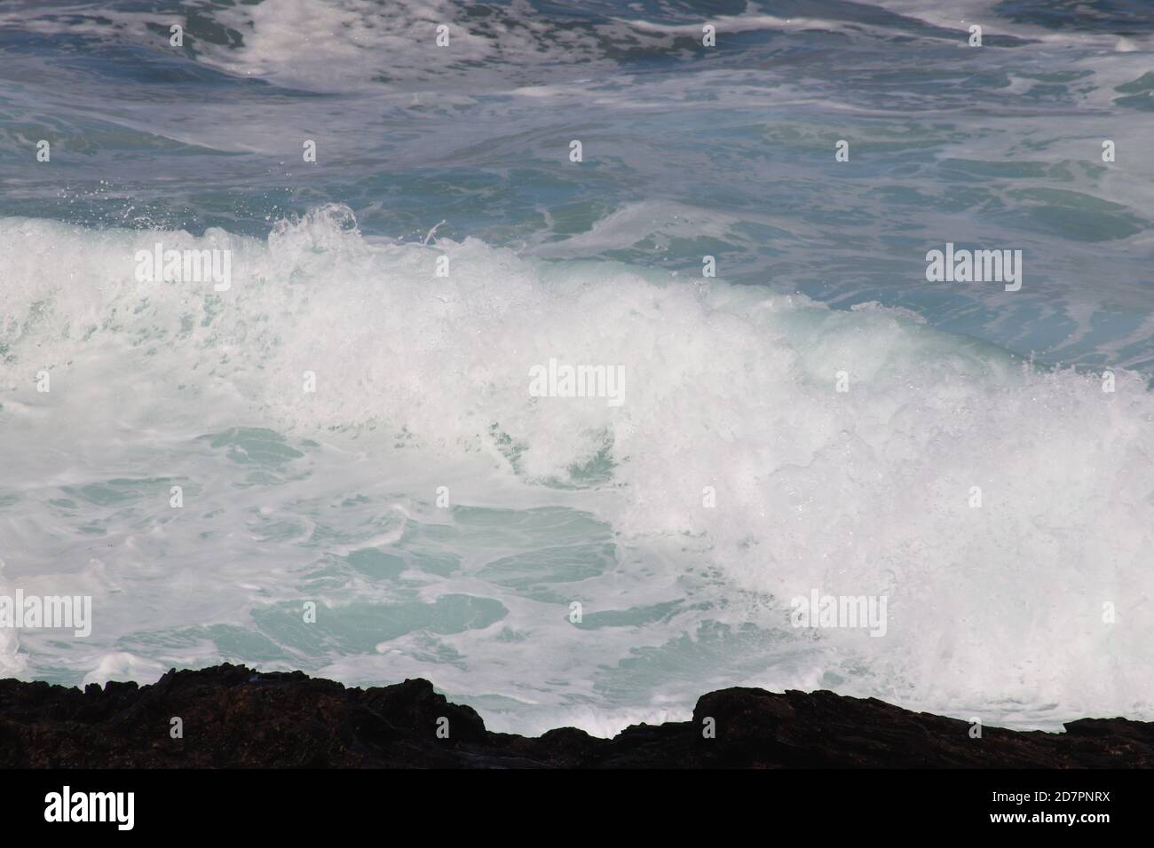 Waves breaking on rocks Stock Photo - Alamy