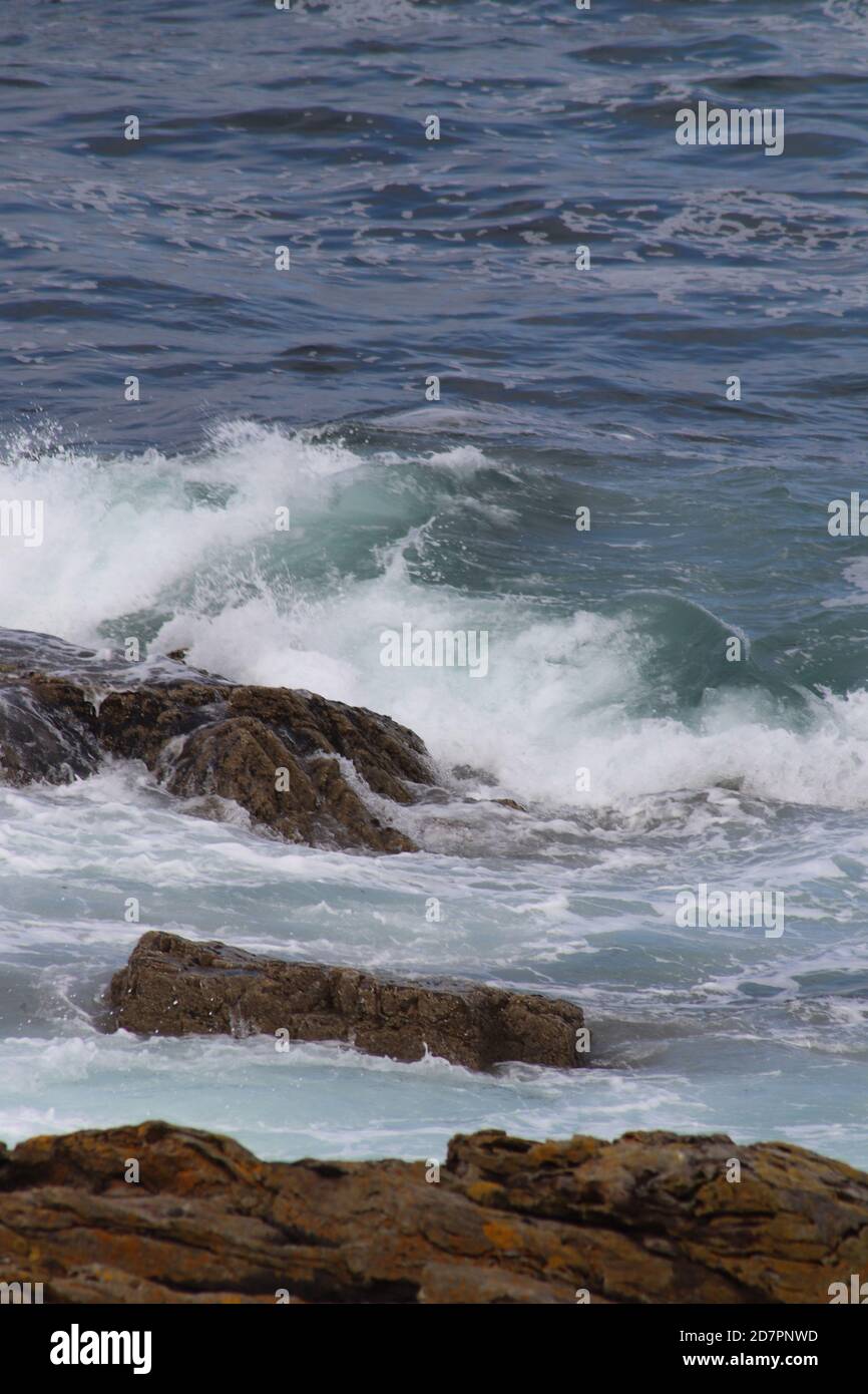 Waves breaking on rocks Stock Photo - Alamy