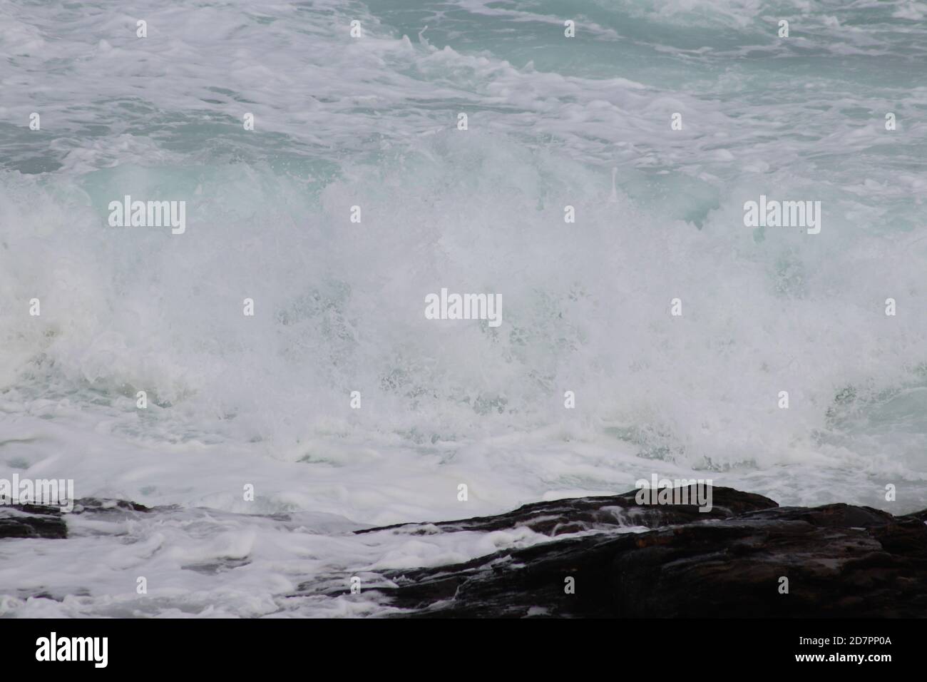Waves breaking on rocks Stock Photo - Alamy