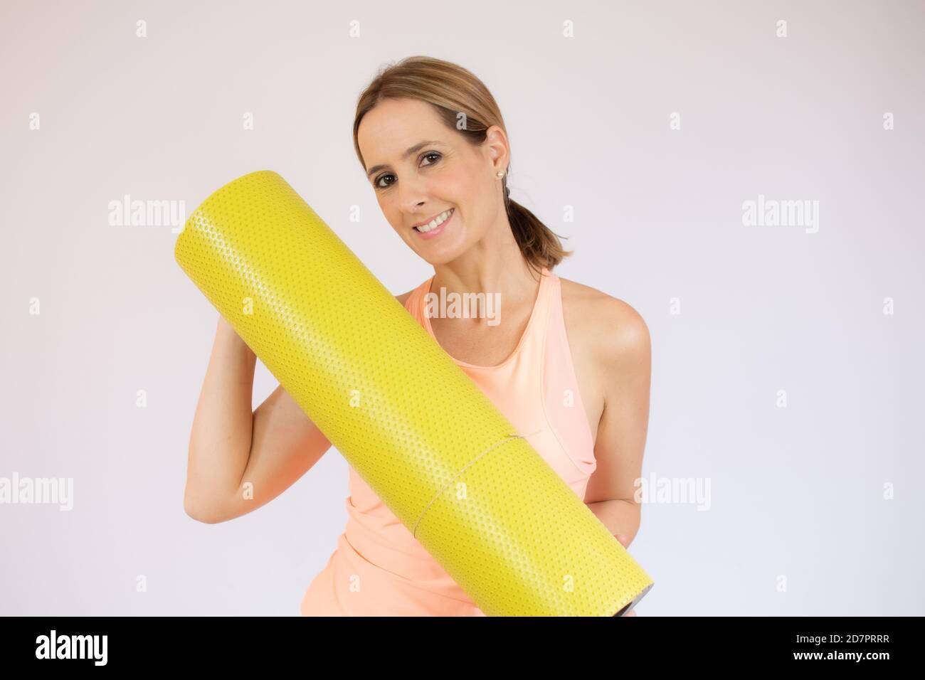 Beautiful woman holding yoga mat in hand over white background Stock ...