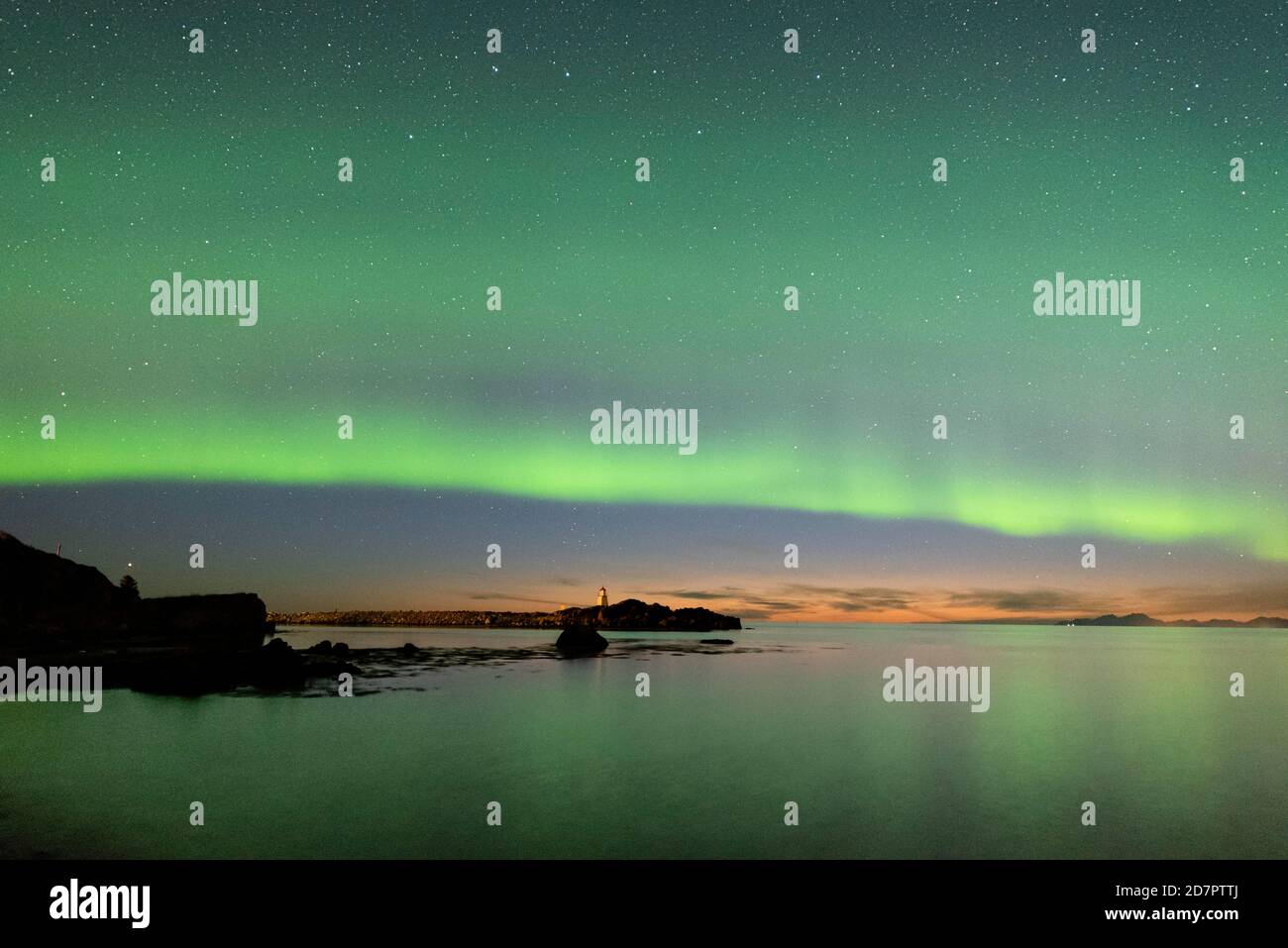 Northern lights over the sea, island with small lighthouse, Vagan ...