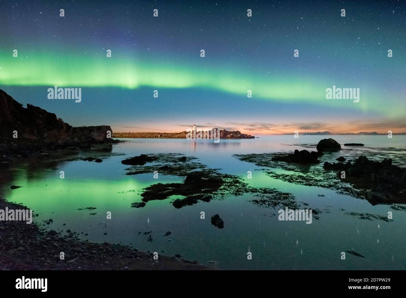 Northern lights over the sea, island with small lighthouse, Vagan ...