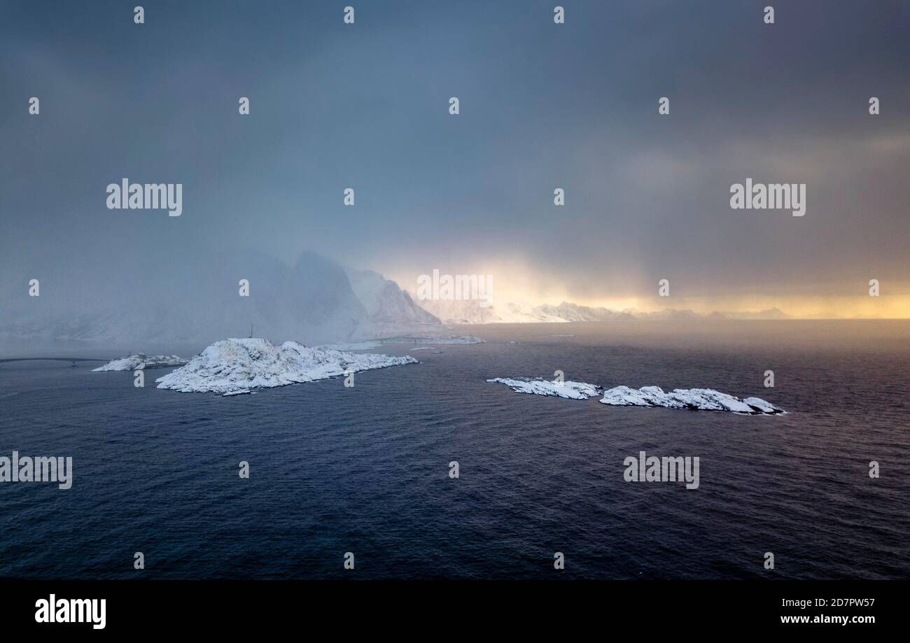 Snowfall over the sea and mountains, dense clouds, Reine, Nordland ...