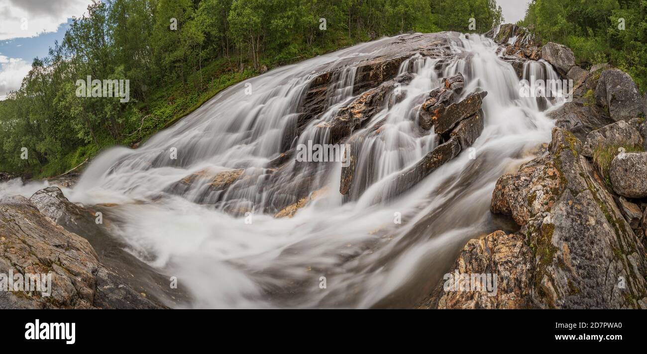 Wide waterfall flows over rocks in the forest hi-res stock photography ...