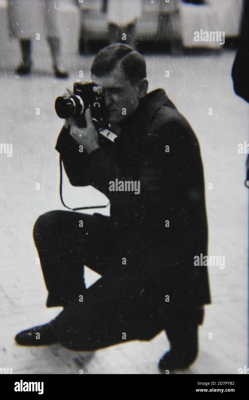 Fine 1970s vintage black and white photography of a man taking a ...