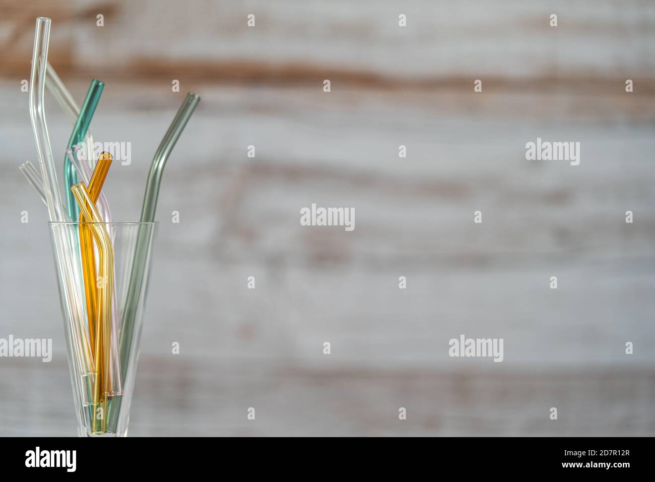 Glass straws in glass with wood background and copy space Stock Photo ...