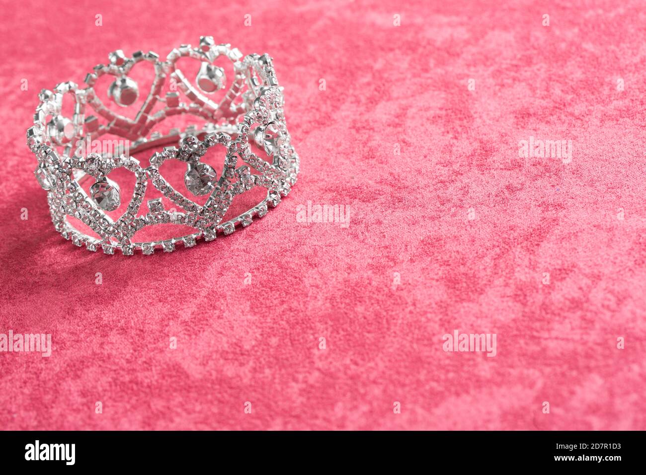Silver Crown on a Pink Velvet Background Stock Photo - Alamy