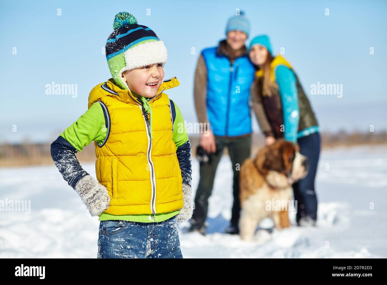 happy playing family with St. Bernard dog in the winter. people ...