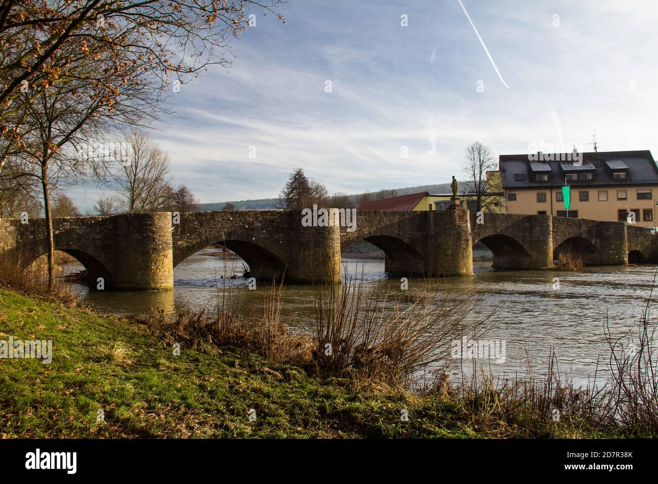 Old brick arch bridge over Tauber river in Tauberrettersheim, Germany ...