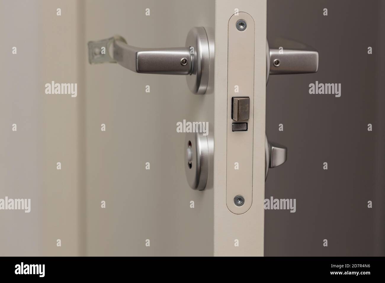 Close up view of lock and handle buffer rubber on white door. Interior ...