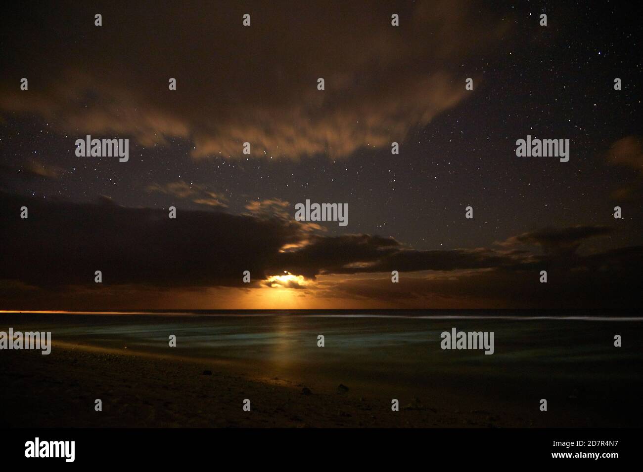 Moon setting over Pacific Ocean, and stars, Aroa Beach, Rarotonga, Cook ...