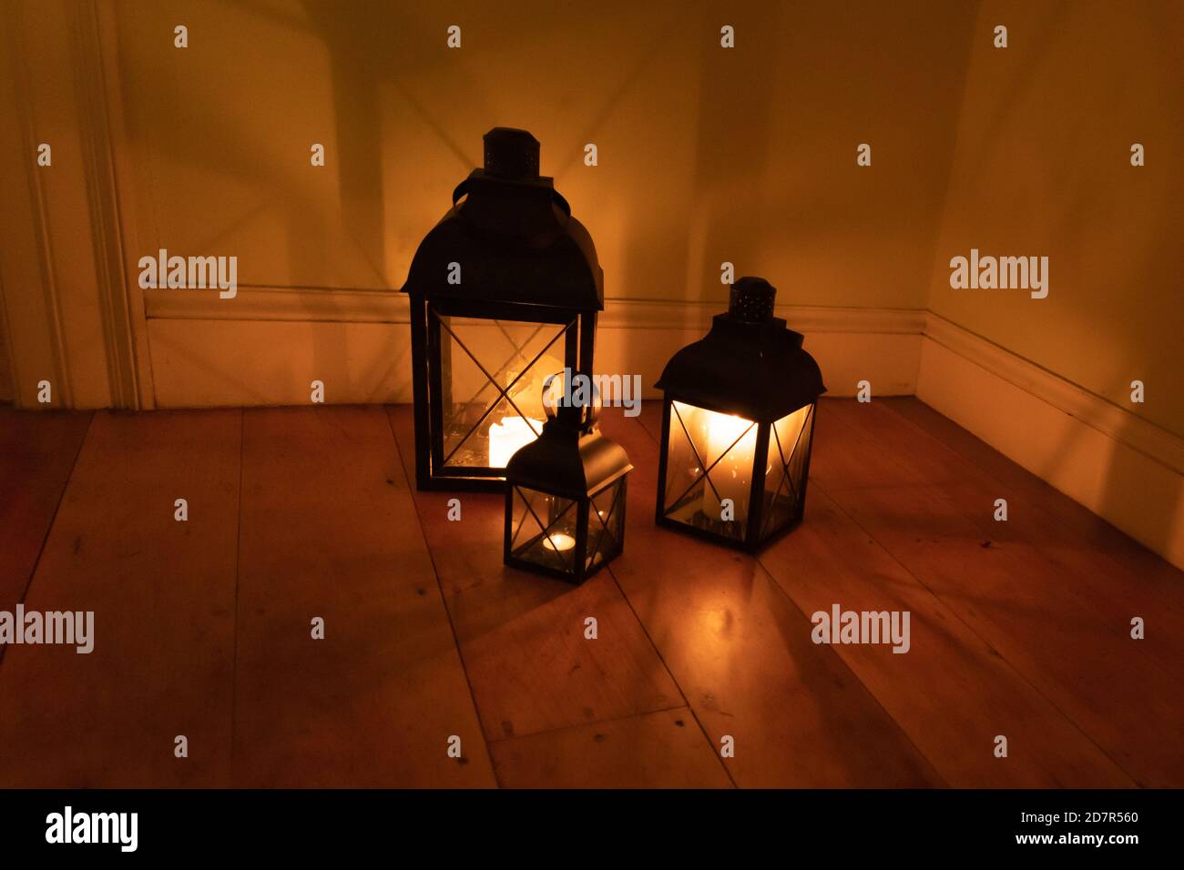 Three vintage lamps lay in the corner of a room with wooden hardwood ...
