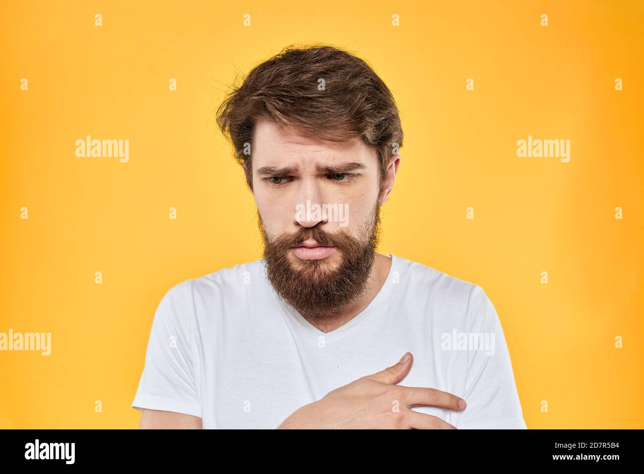 Man in white t-shirt emotions studio gestures with hands displeased ...