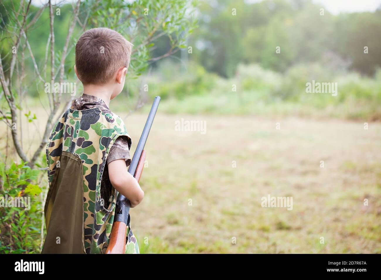 Boy with shotgun while dove hunting Stock Photo - Alamy