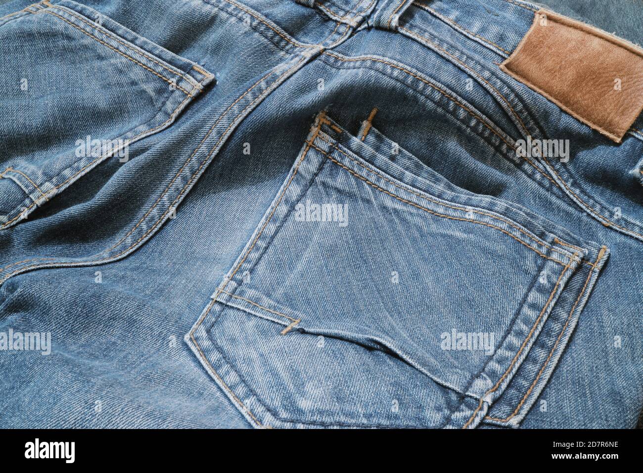 Textured background of blue denim jeans with seam and thread stitch ...