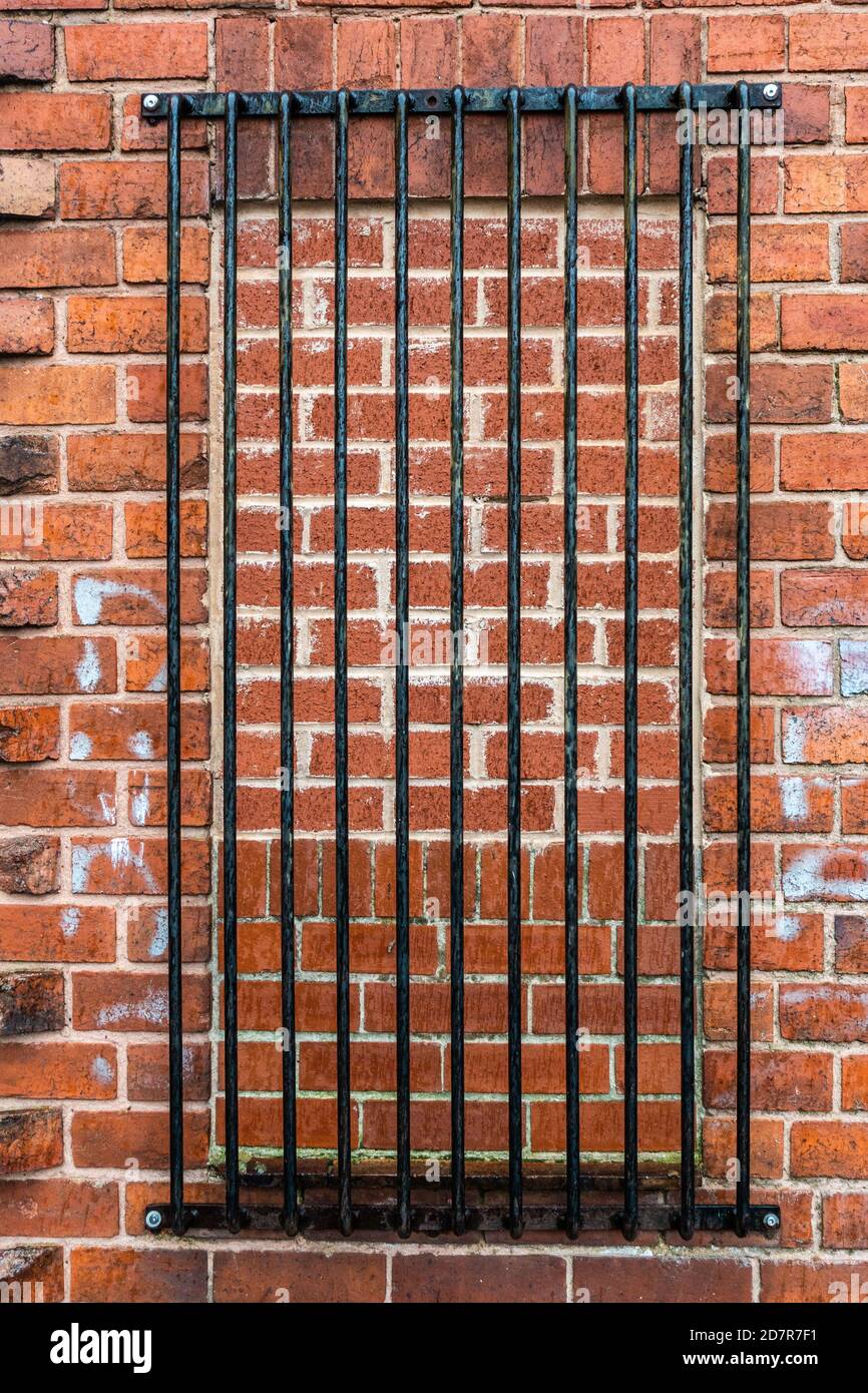 Black metal bars blocking a bricked up window in a brick wall Stock ...