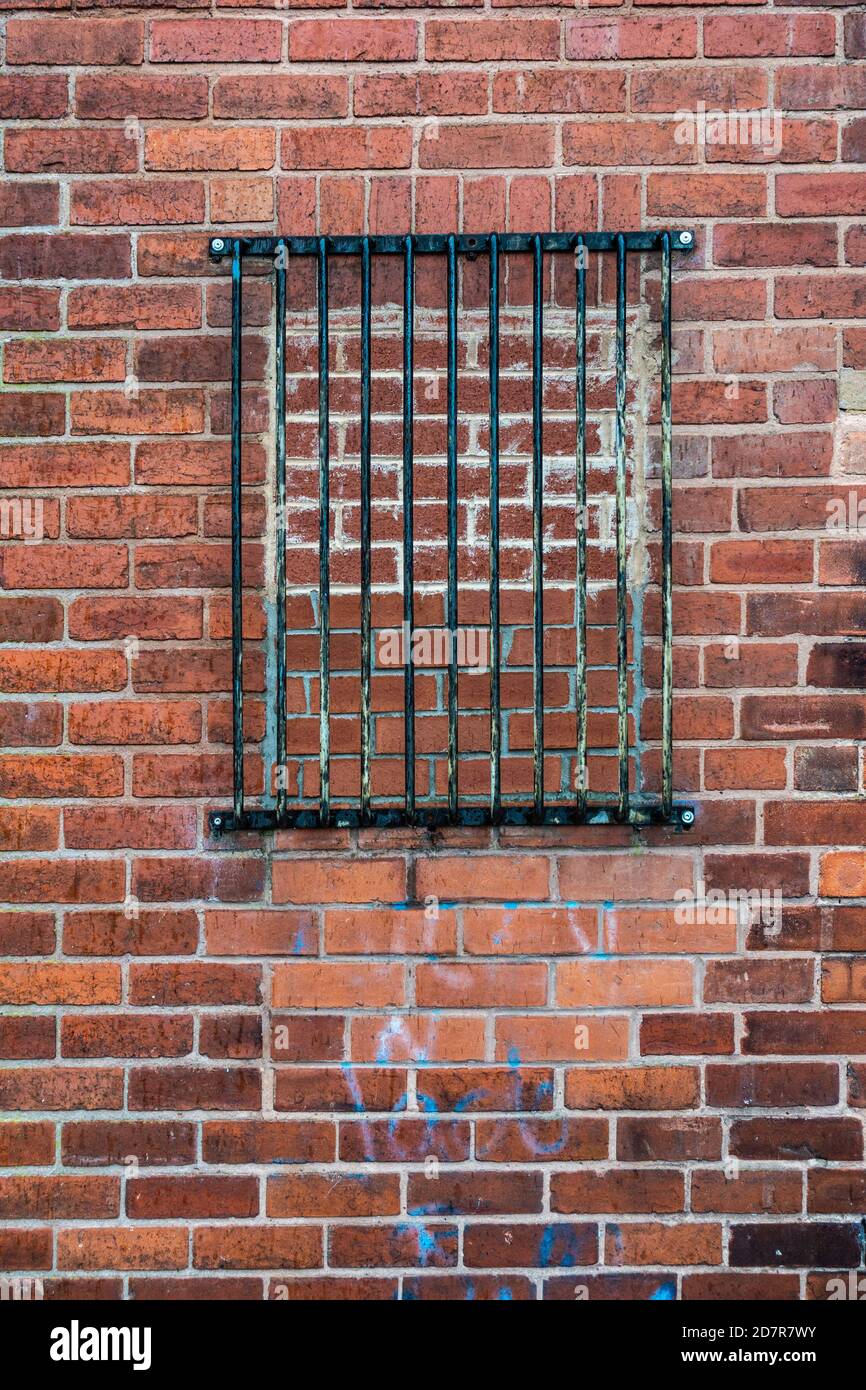 Black metal bars blocking a bricked up window in a brick wall Stock ...