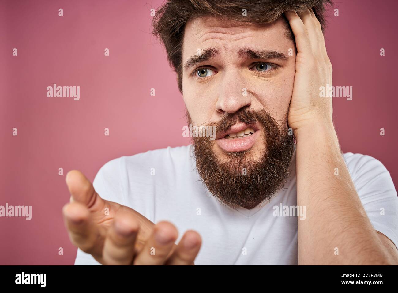 bearded man in white t-shirt emotions displeased facial expression ...