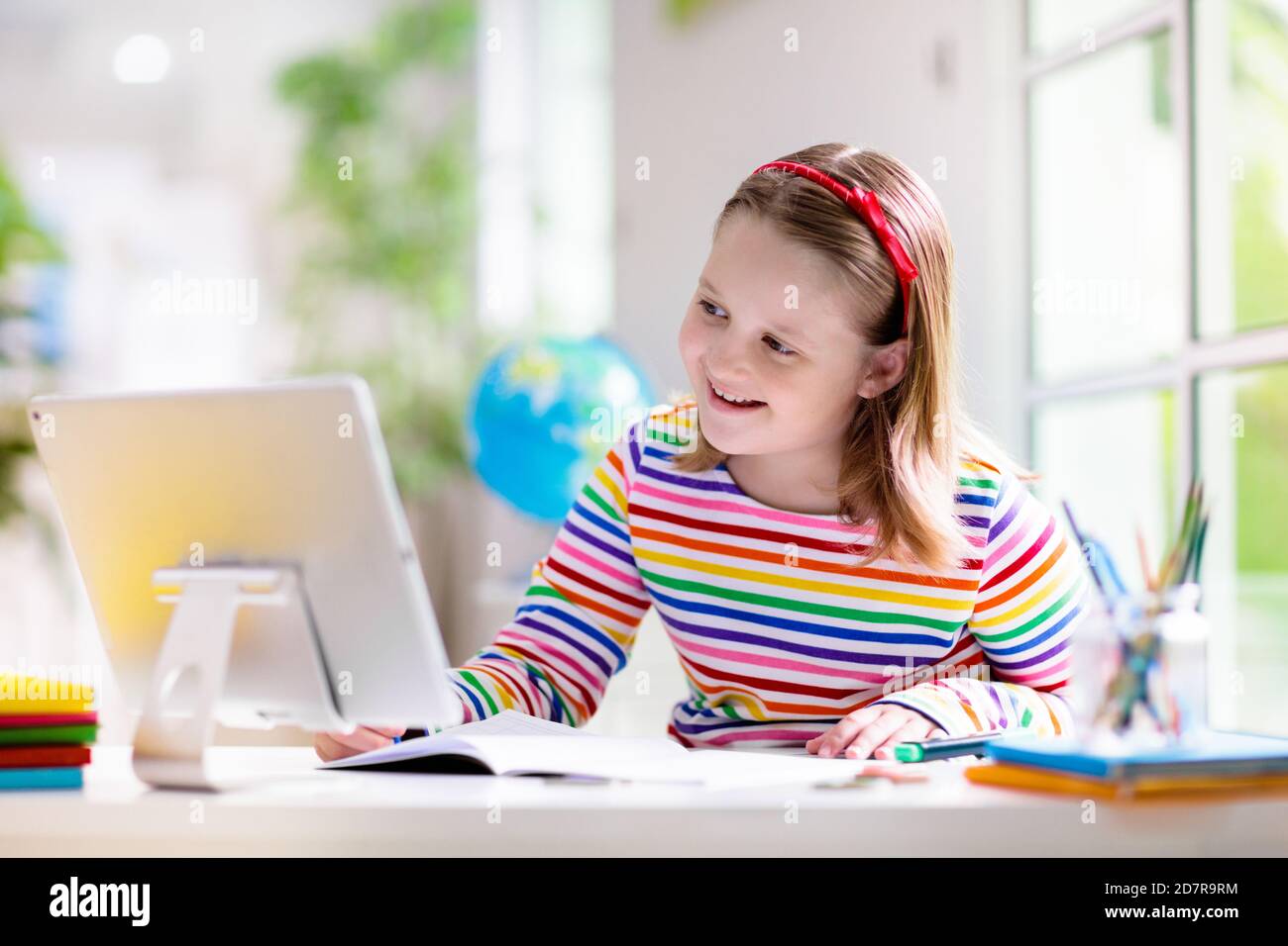 Online remote learning. School kids with computer having video ...