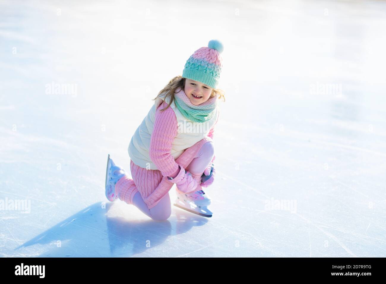 Child skating on natural ice on sunny winter day. Kids with skates ...