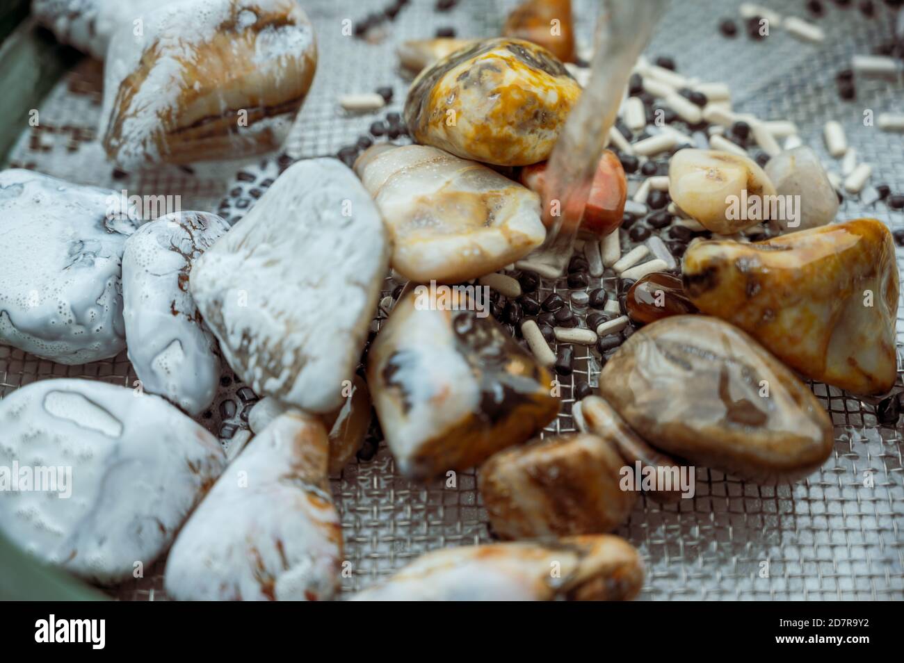 Last step in cleaning polished rocks - common hobby Stock Photo - Alamy