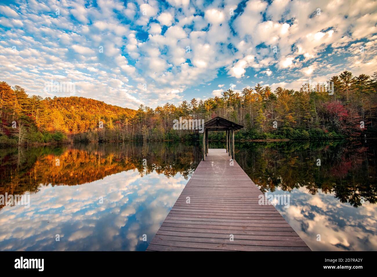 Wooden pier on Lake Dense in autumn with cloud reflections - DuPont ...