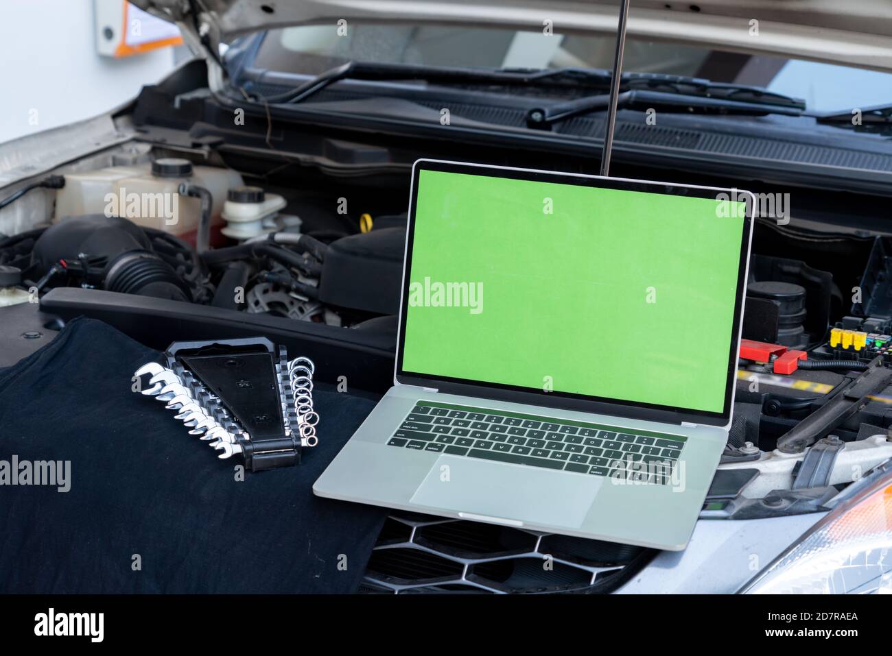 Laptop computer on car hood for engine diagnostic. Car garage repair ...