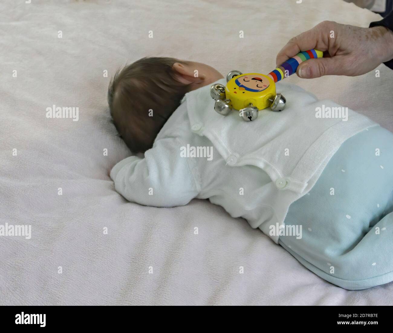 Motor skills class and early stimulation with baby, colorful toys and ...