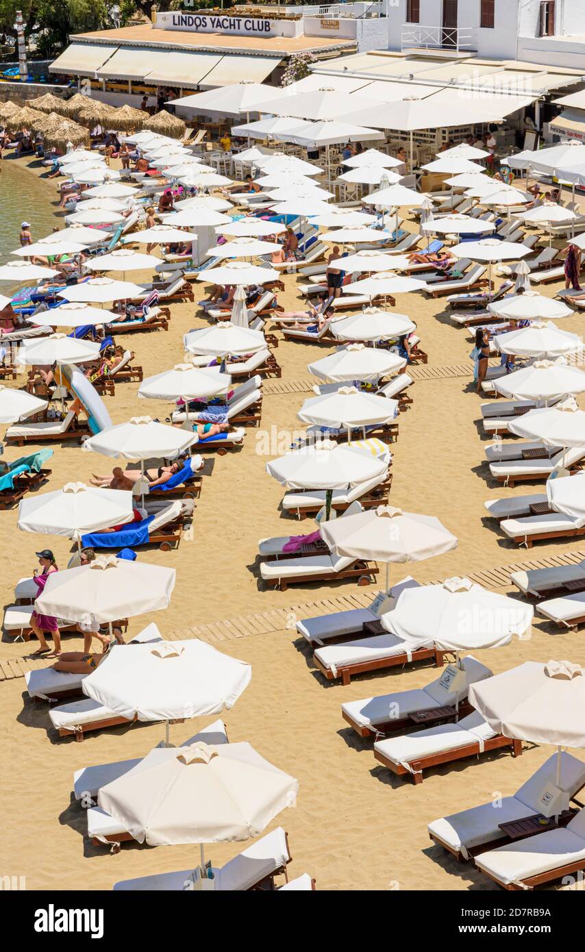 Rows of sun beds with beach umbrellas on Pallas Beach, Lindos, Rhodes ...