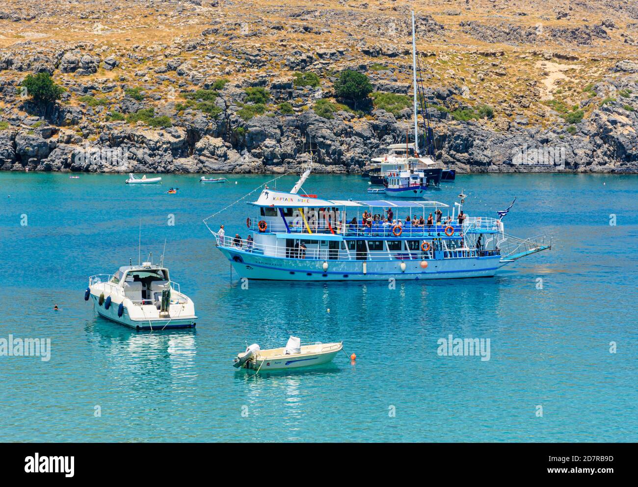 Tourist boat moored at Lindos bay, Lindos, Rhodes, Greece Stock Photo ...