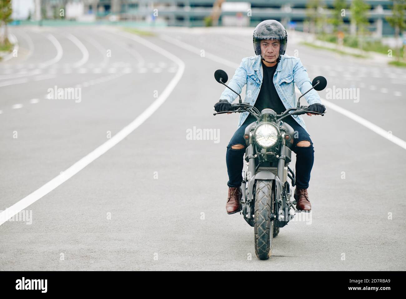 Motorcyclist riding fast Stock Photo - Alamy