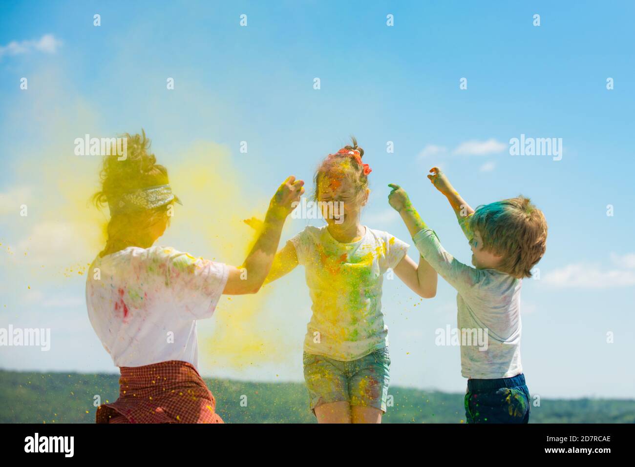 Cute children celebrate Indian holi festival with color Stock Photo - Alamy