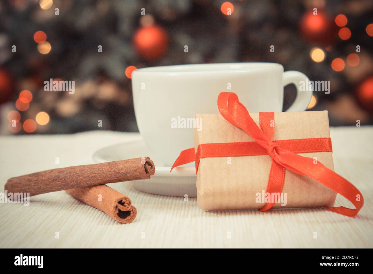 Vintage photo, Wrapped gift with ribbons for xmas, cup of hot tea or ...