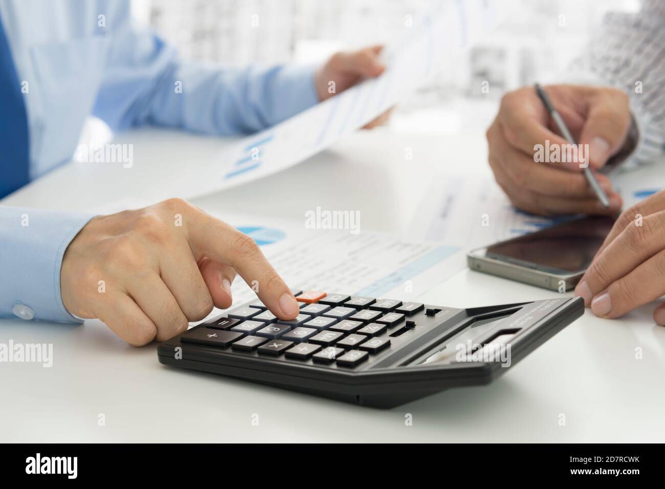 Businessman using a calculator to calculate the numbers. Concept of ...
