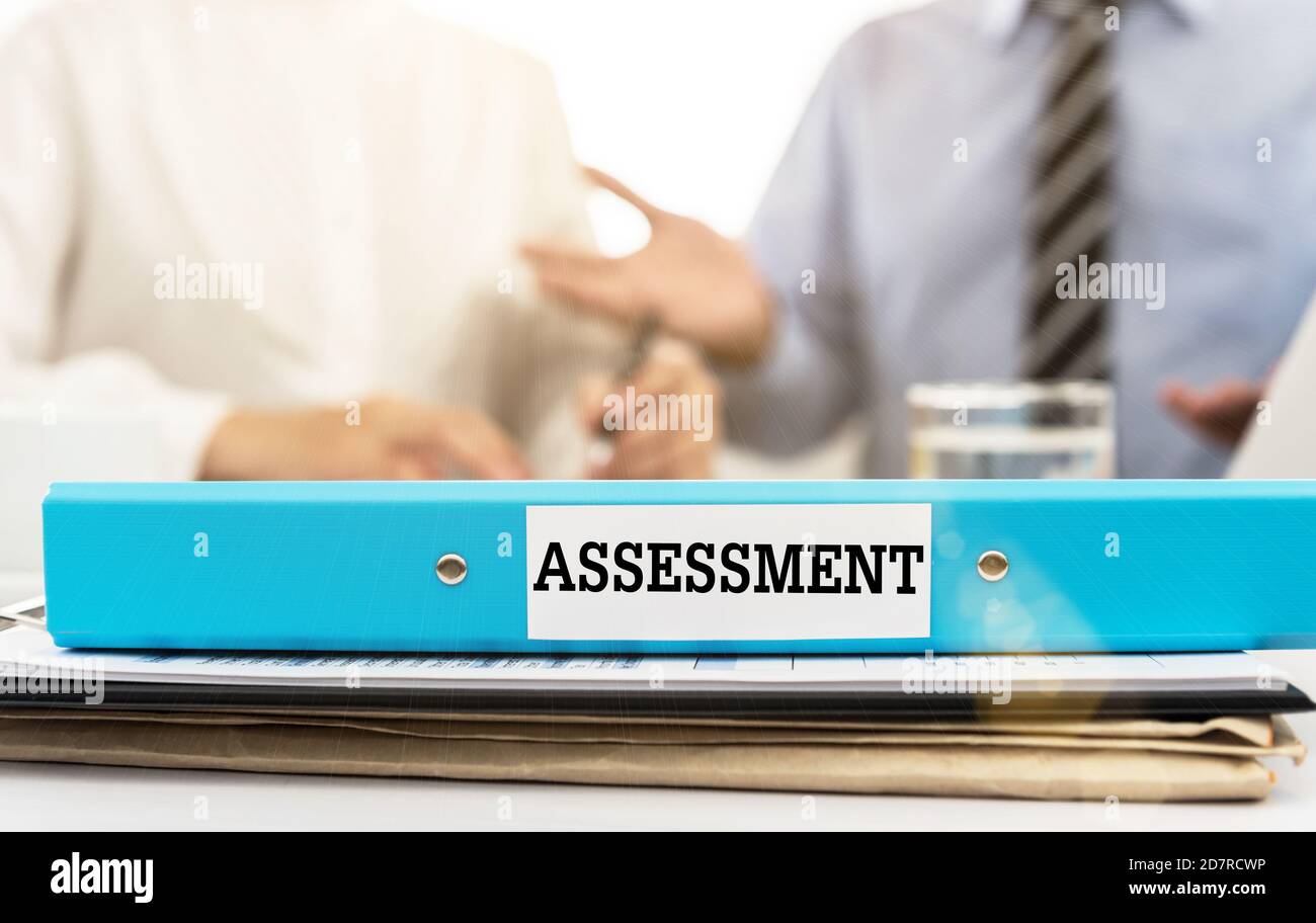 Assessment result documents folder on desk in meeting room. Concept of ...