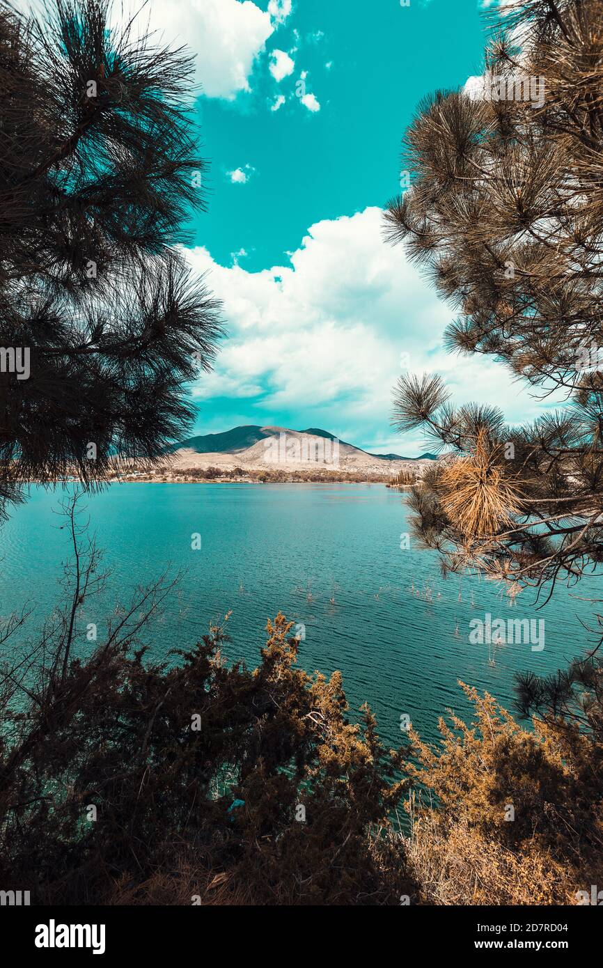 Beautiful landscape view between trees framing lake and mountain Stock ...