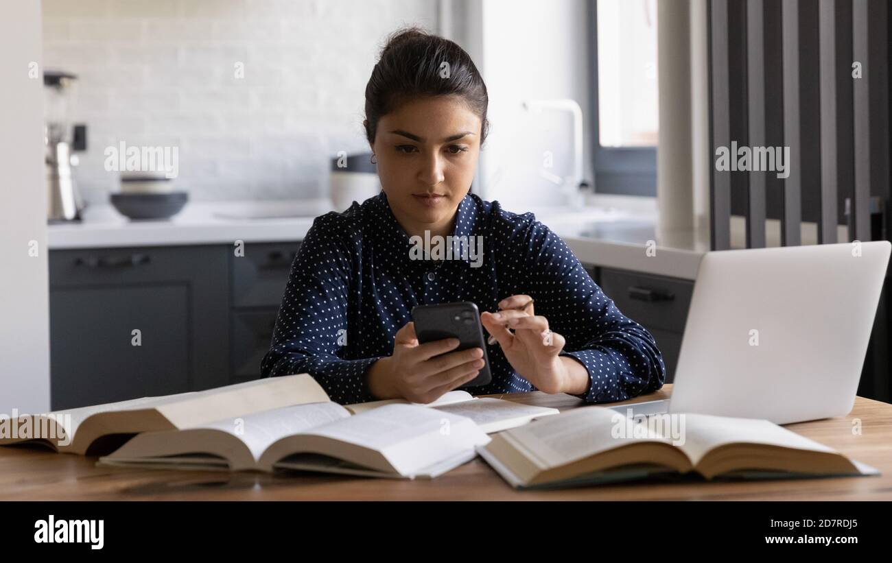 Millennial Indian woman study with gadgets at home Stock Photo - Alamy
