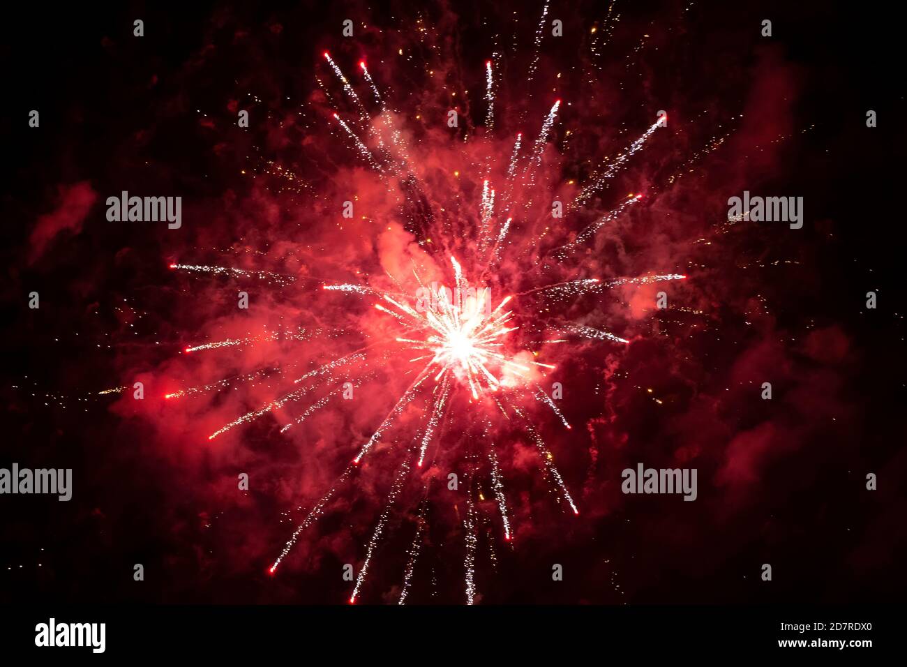 On a black background, a red explosion of fireworks with smoke. Festive ...