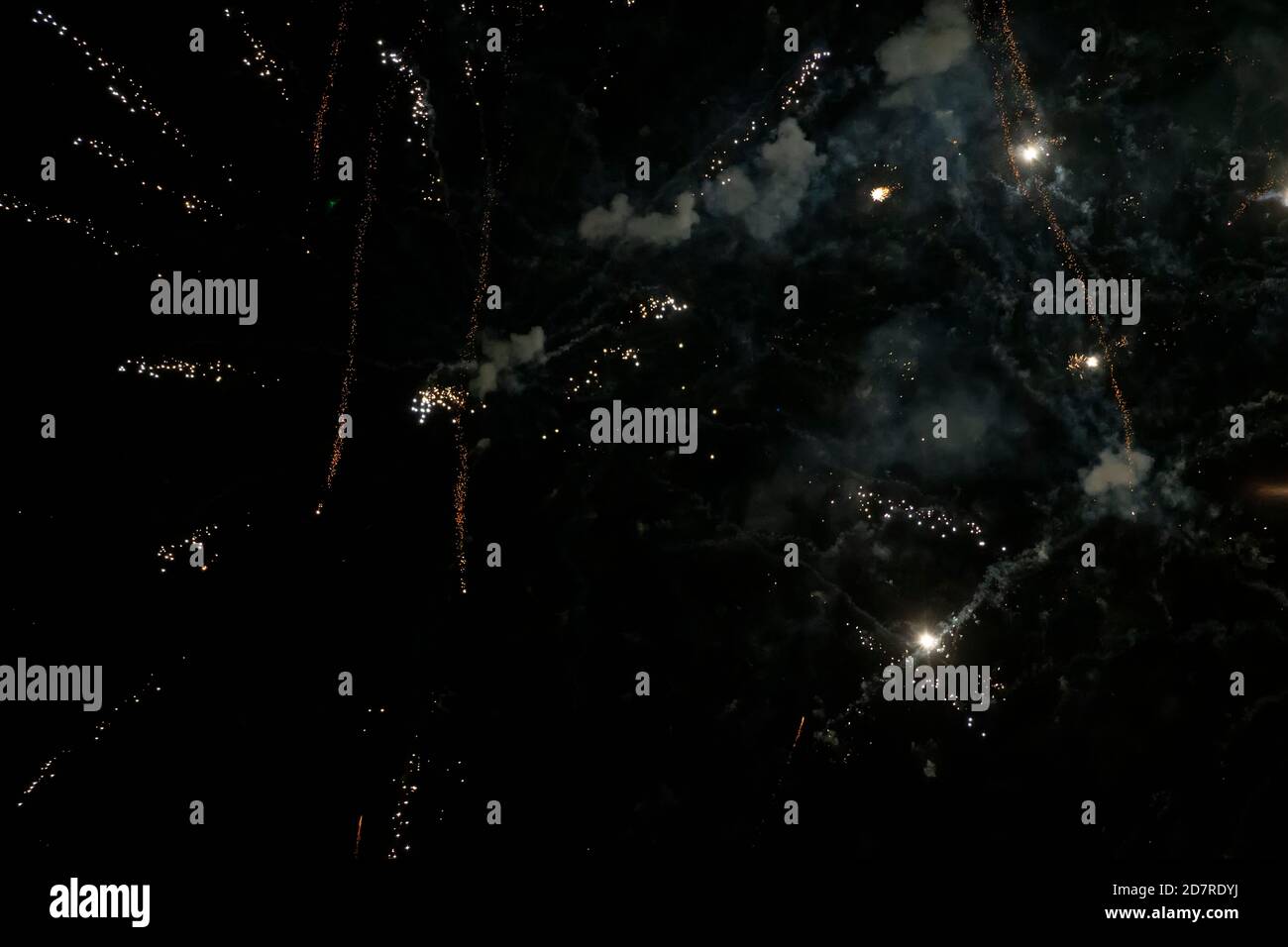 Golden rare stripes of fireworks with smoke and bokeh on a black ...