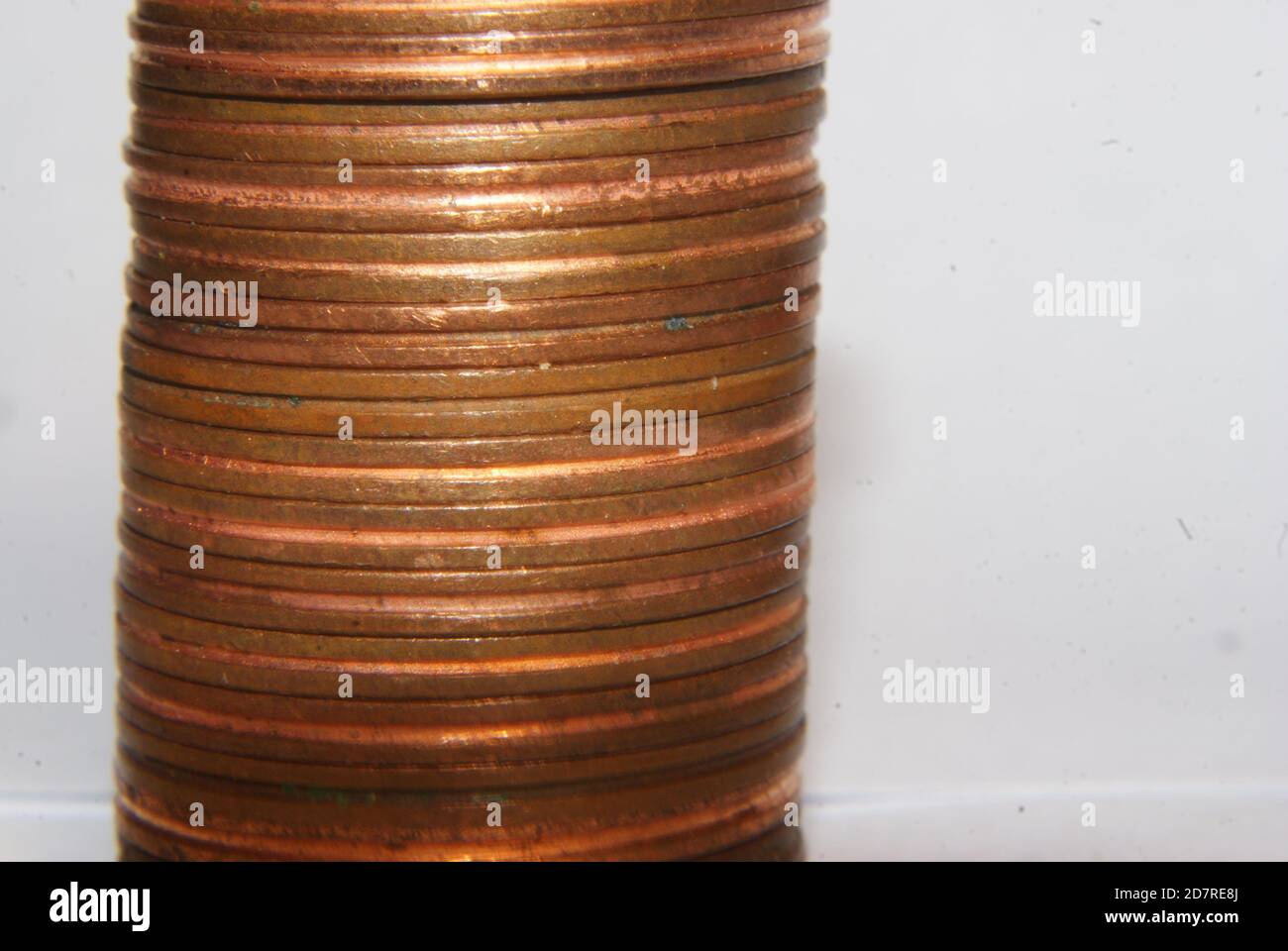 Closeup of a copper coin pile on white background Stock Photo - Alamy