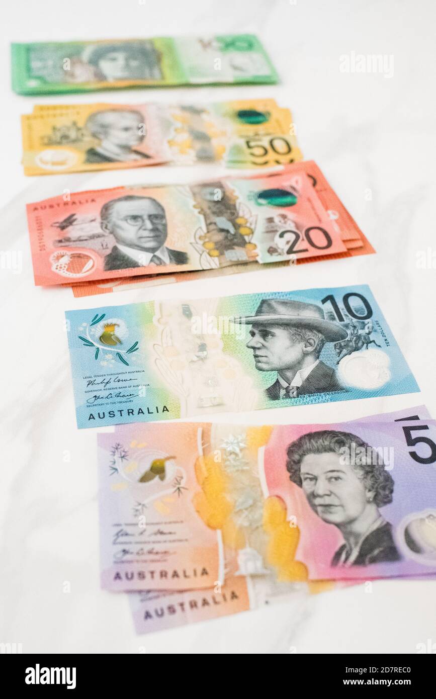 Vertical shot of Australian dollar banknotes on the white background ...