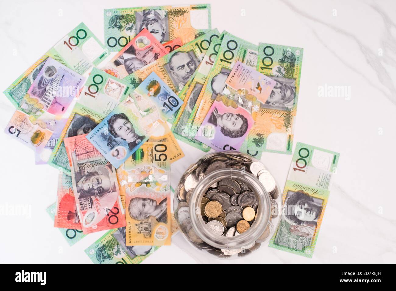 Top view of a jar with coins and Australian dollar banknotes on the ...