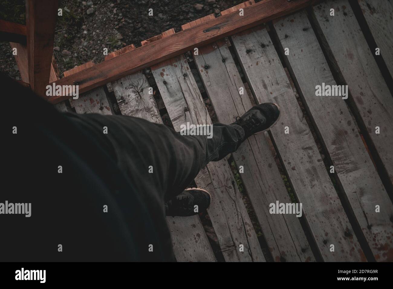 First-person view of feet and the wooden walkway Stock Photo - Alamy