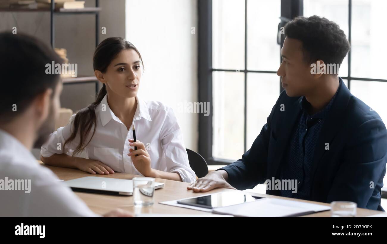 Multiracial employees brainstorm ideas at office meeting Stock Photo ...