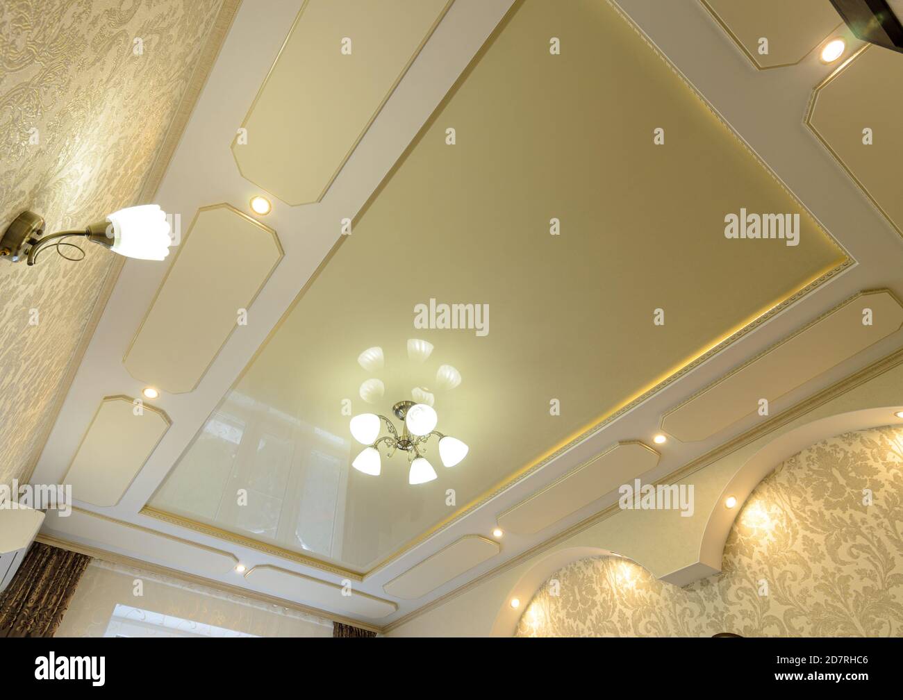 View of a beautiful rich tiered stretch ceiling in gold tones Stock ...