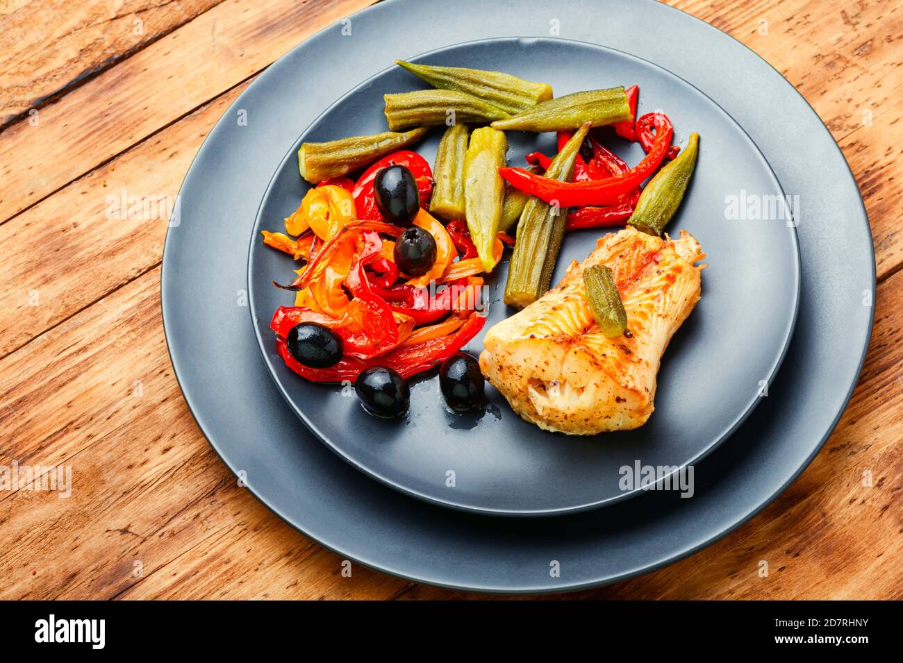 Baked fish with okra and red pepper.Fish grenadier Stock Photo - Alamy