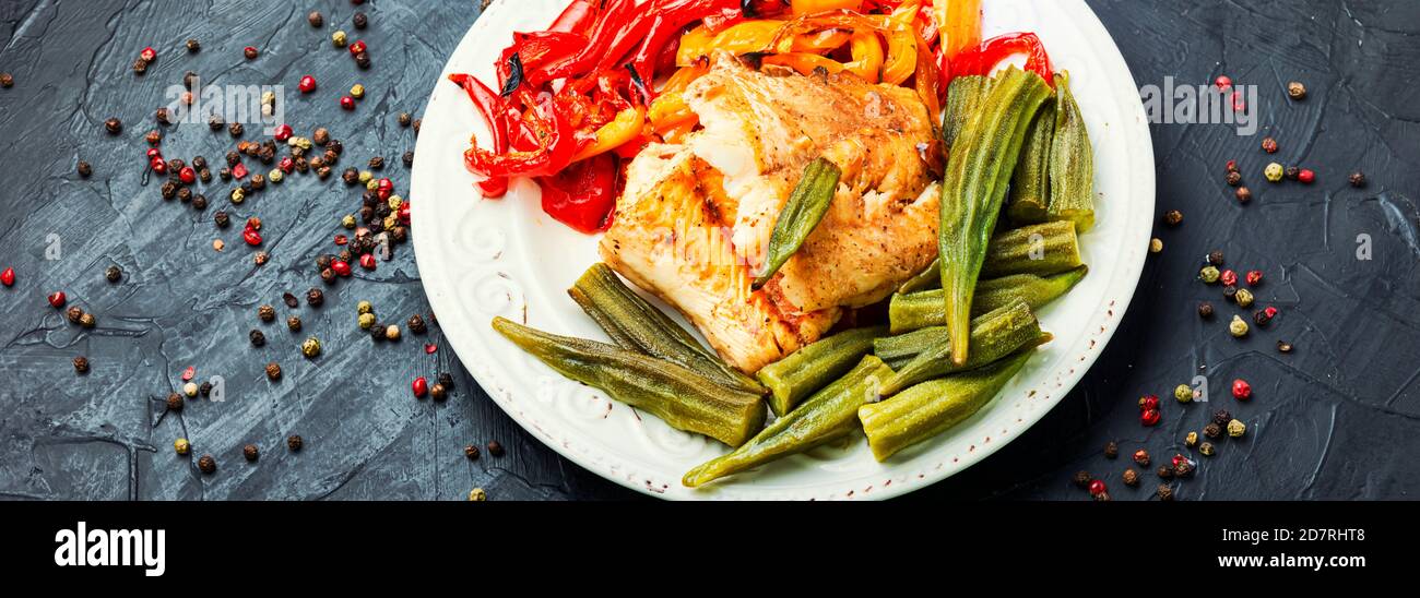 Tasty fish grenadier baked with vegetables.Seafood on slate background ...