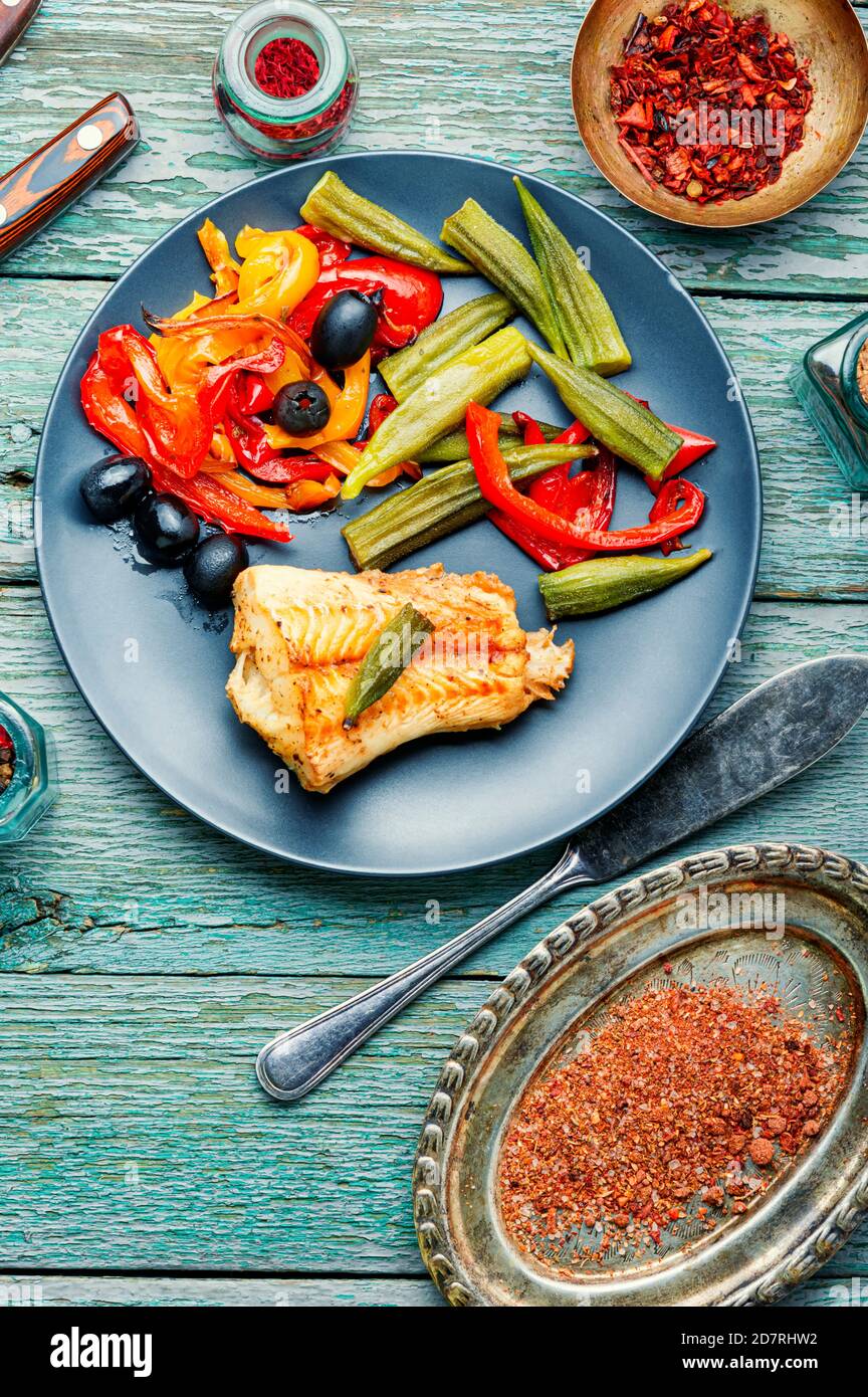 Baked fish with okra and red pepper.Fish grenadier Stock Photo - Alamy