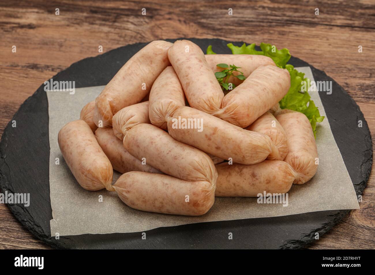 Raw natural chicken baby sausages for roast Stock Photo - Alamy